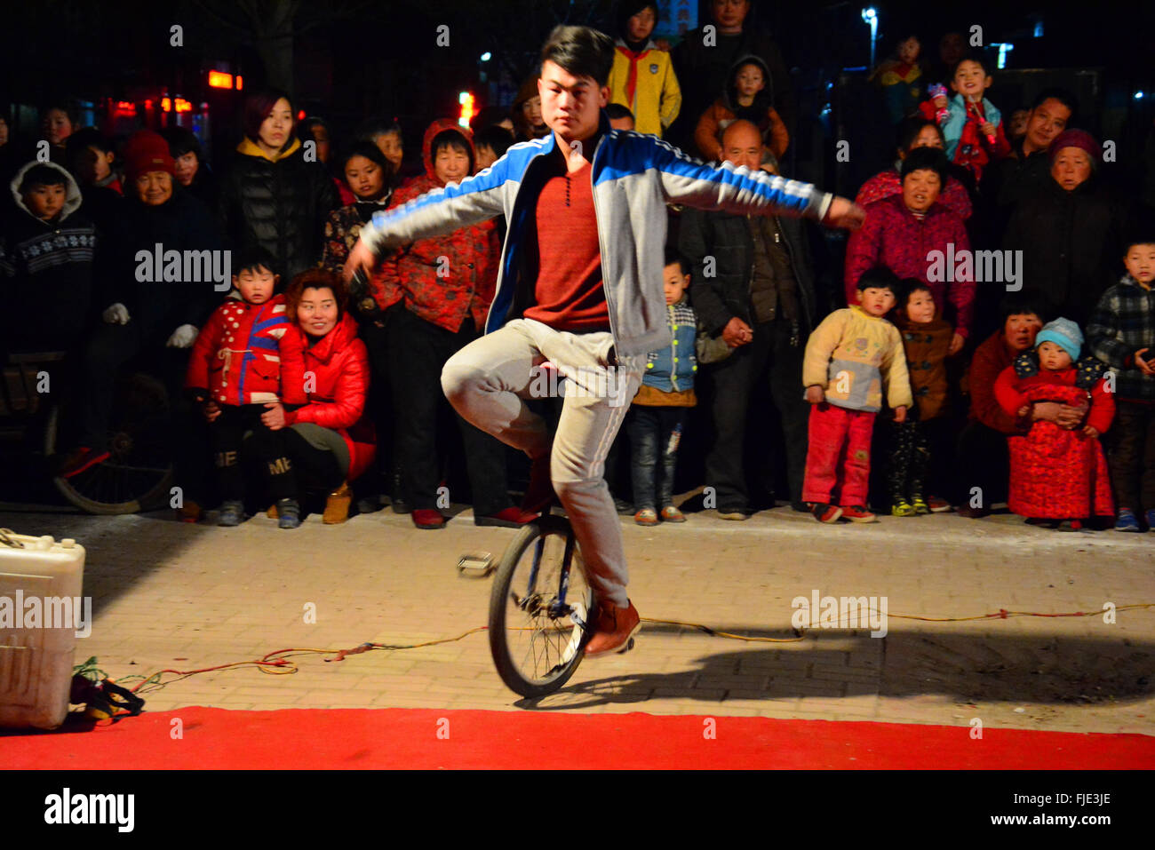 An acrobat is riding on one wheel. Mr Wei and his apprentices just ...