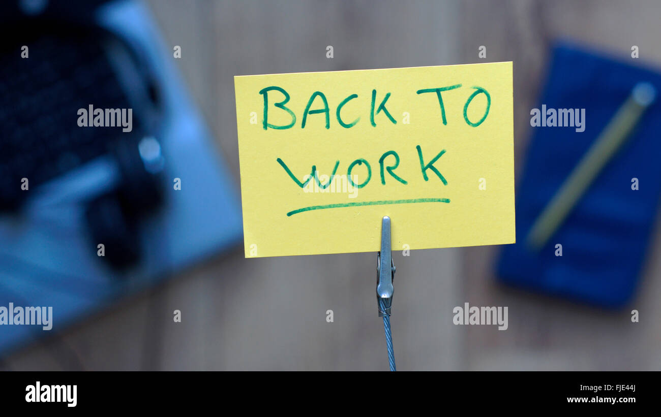 Back to work written on a memo at the office Stock Photo - Alamy