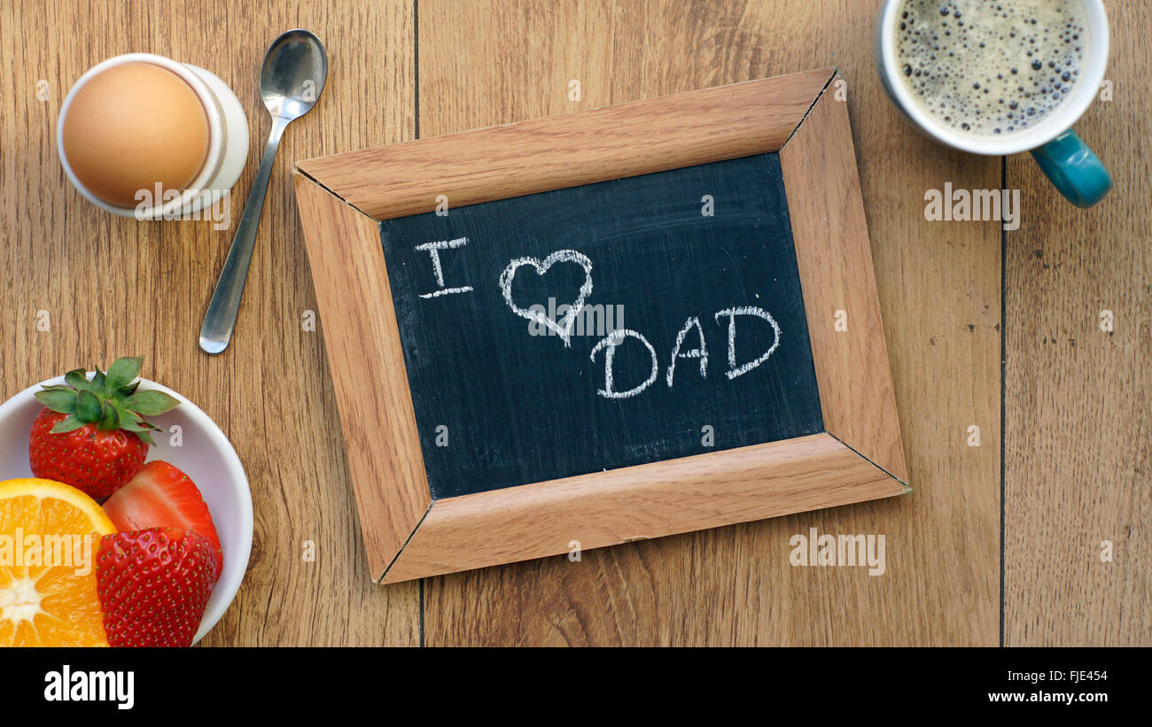 I love dad written on a chalkboard between a breakfast for him Stock ...
