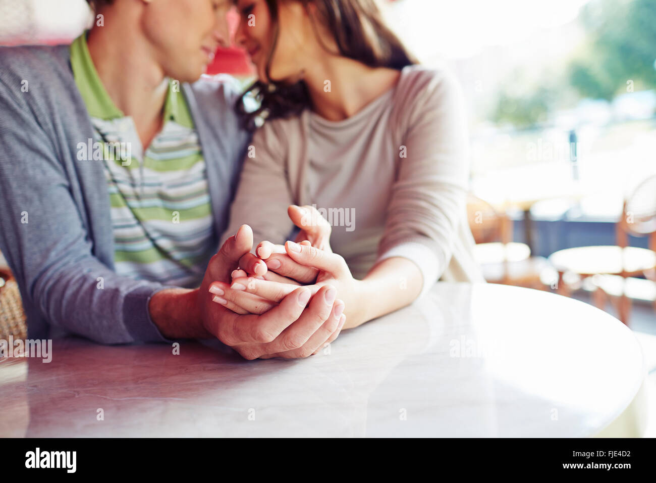 Hands romantic couple sitting table hi-res stock photography and images ...