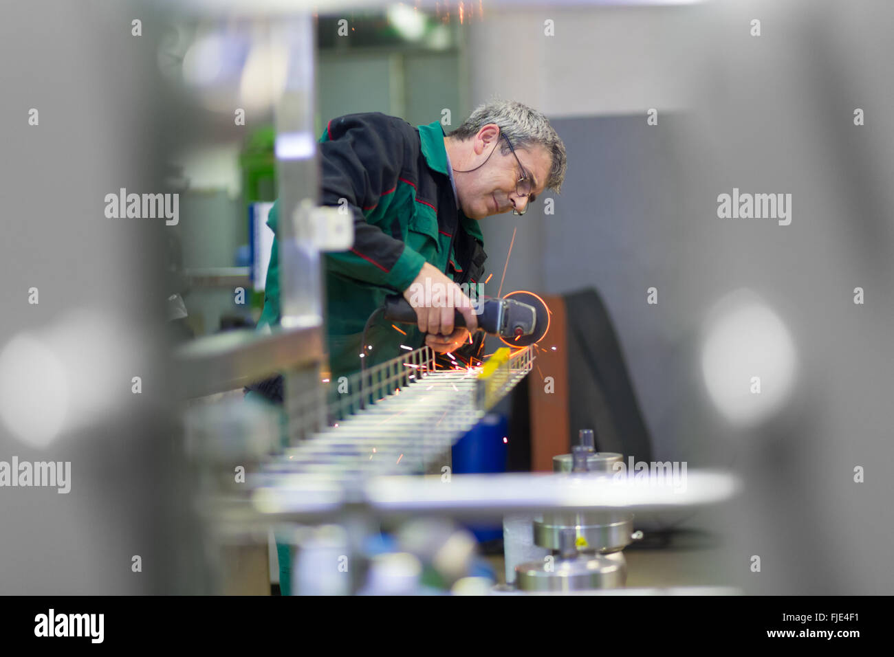 Industrial worker grinding in manufacturing plant Stock Photo - Alamy