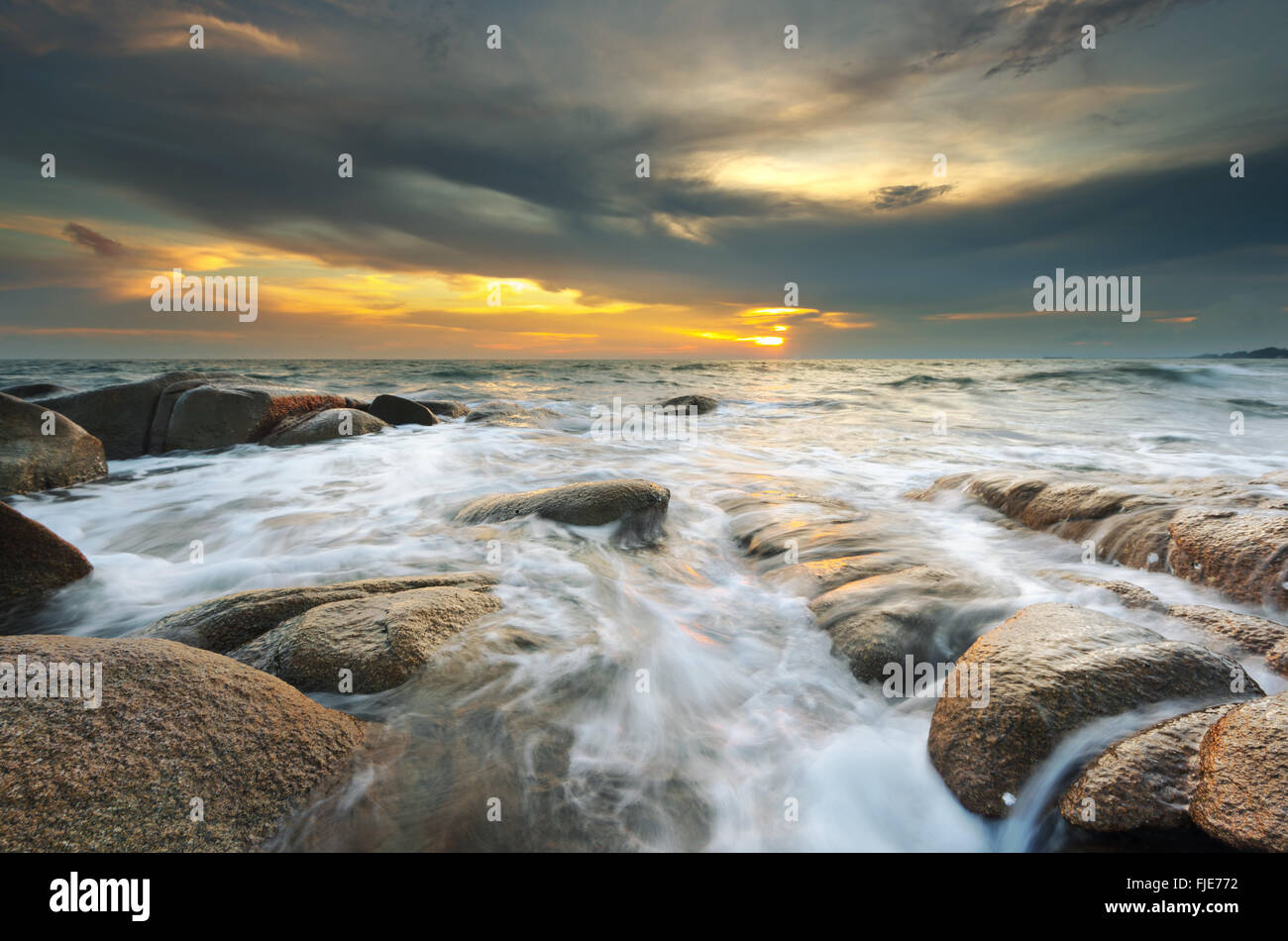stormy sunset wave rock Stock Photo - Alamy