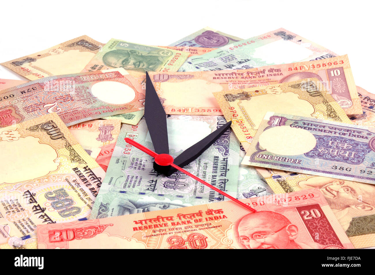 "Time is money" concept - clock and Indian rupee Stock Photo - Alamy