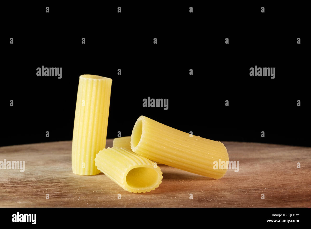 Typical Italian dried pasta on a black background Stock Photo - Alamy