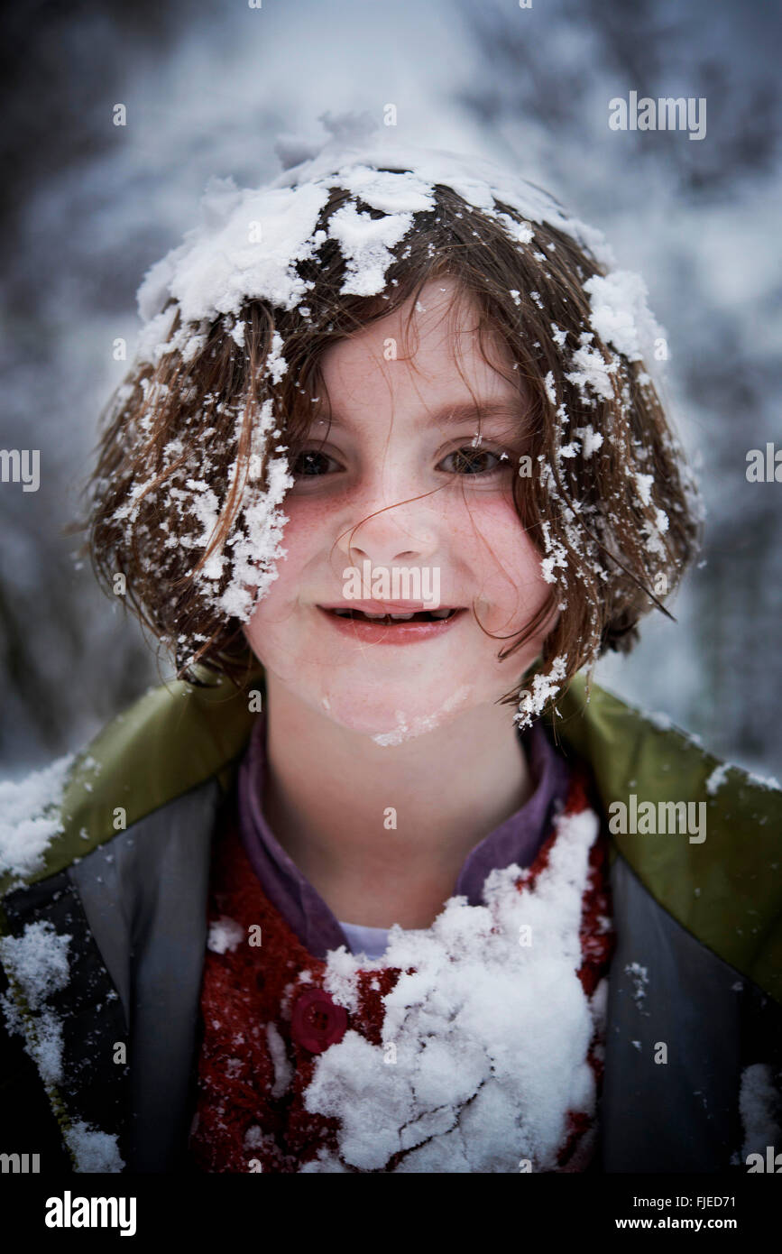 A child covered in snow,snow sticking to her clothes and hair Stock ...