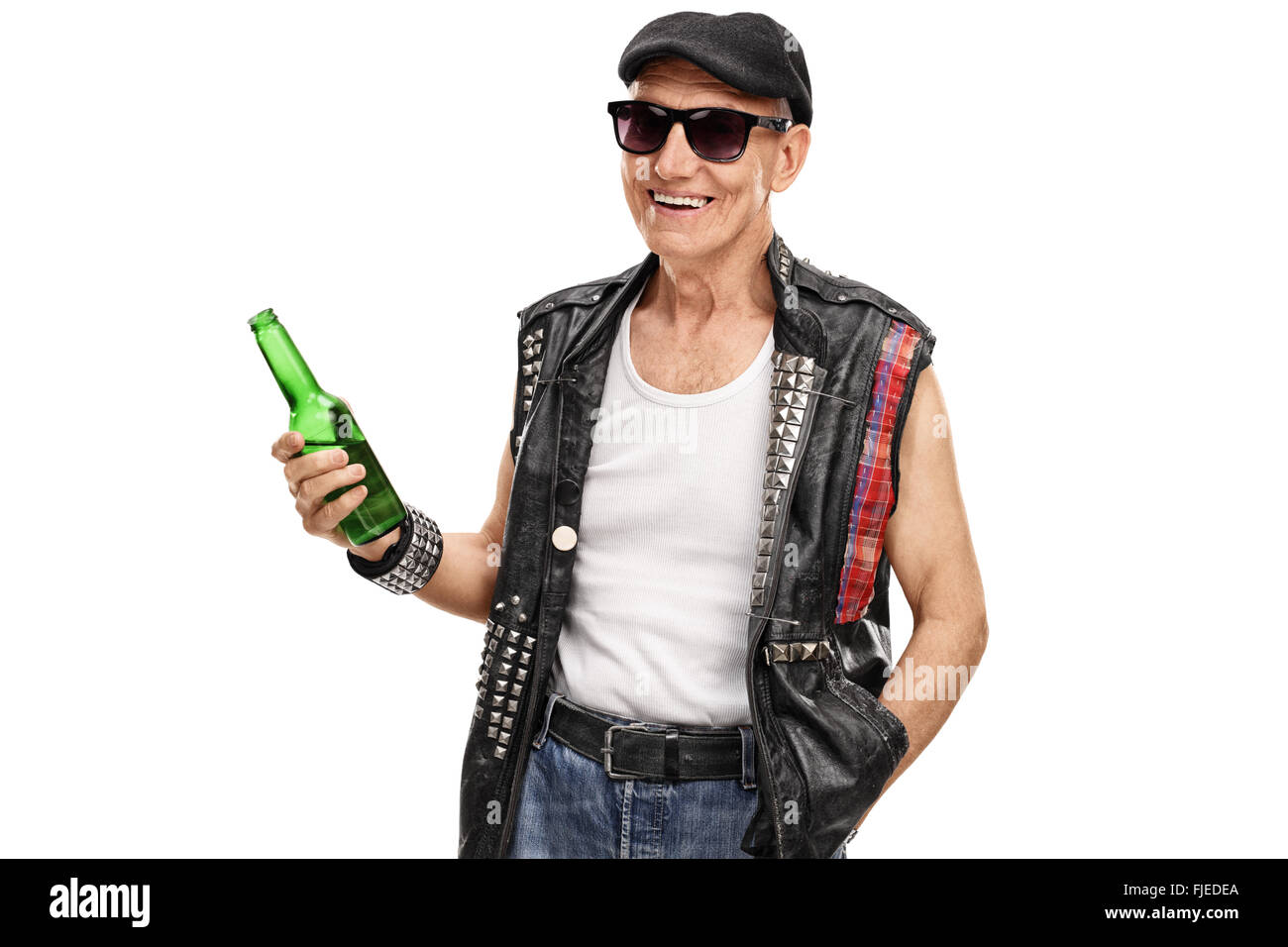 Senior punk rocker with a leather vest with pins holding a bottle of ...
