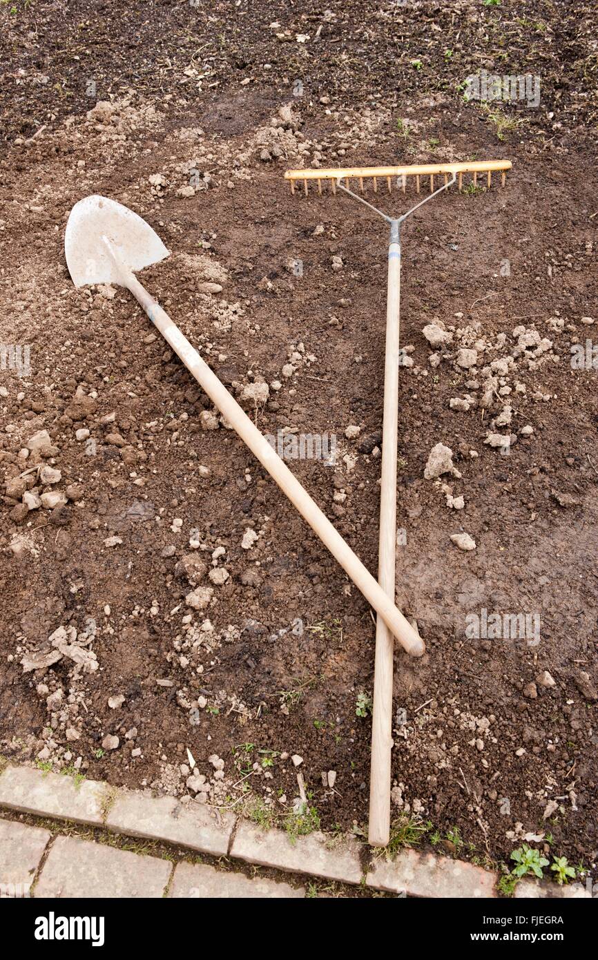 Tools on the ground in the Vegetable Garden at Rosemoor Stock Photo - Alamy