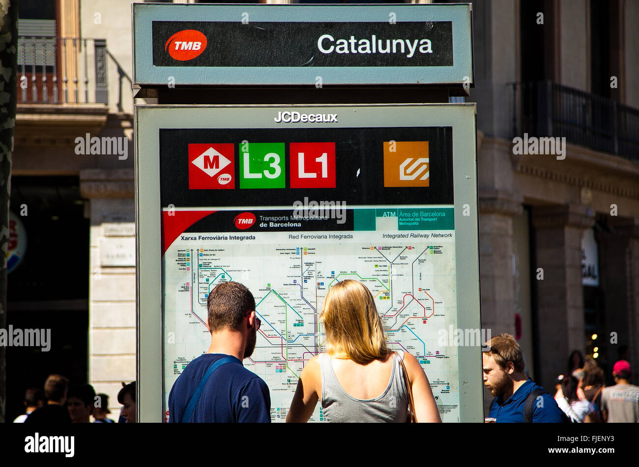 Tourists looking at a railway map at Catalunya station, Barcelona Stock ...