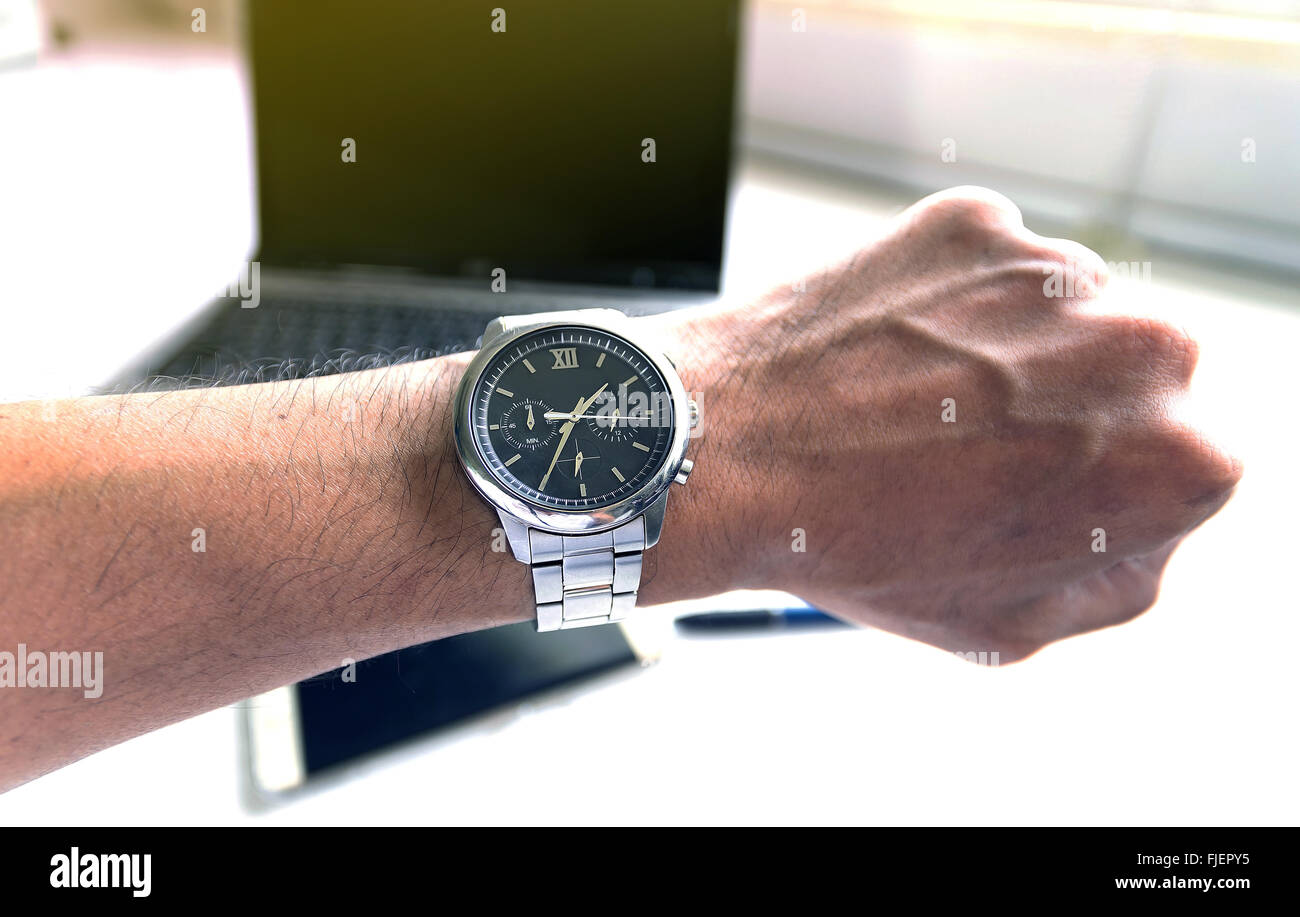 Businessman looking at his wristwatch, it was time to work yet Stock ...