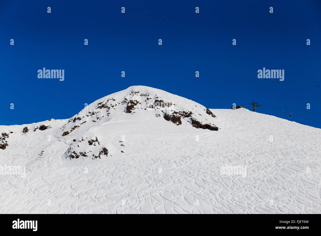 Snowy mountains with ski tracers Stock Photo - Alamy