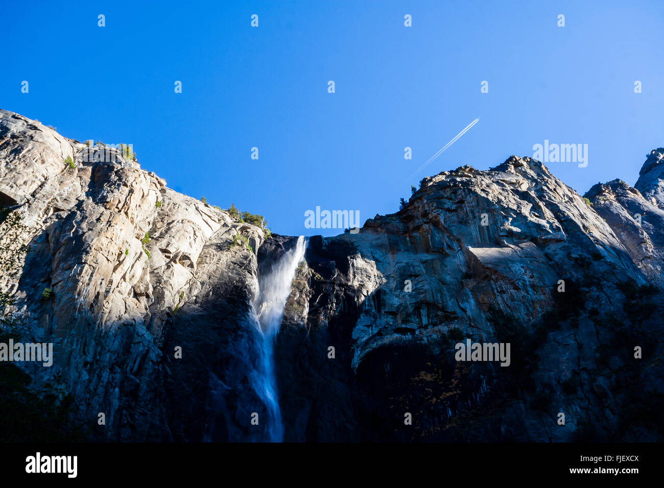 Yosemite, California, USA. Bridalveil Fall with jetplane passing ...