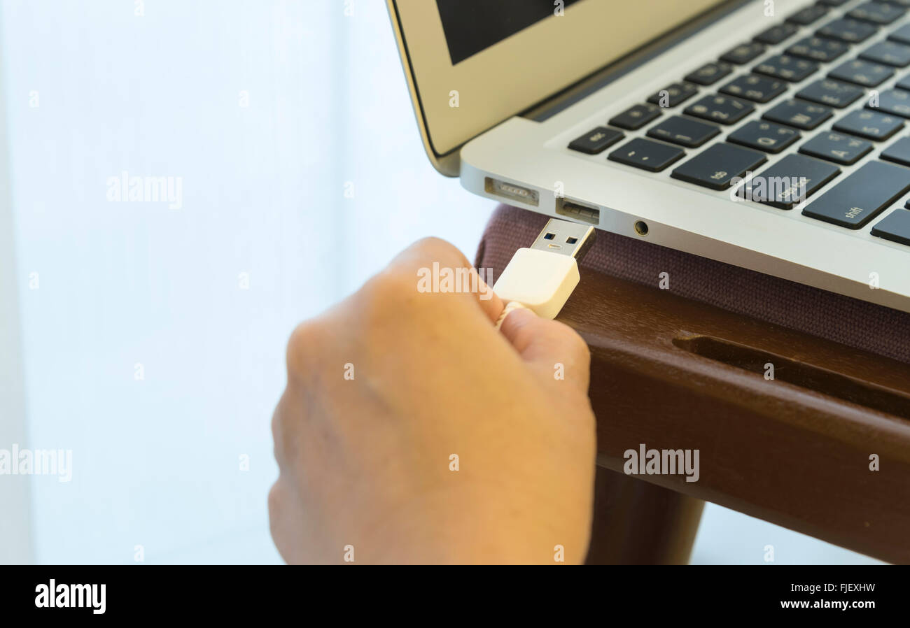 Women plug external devices to the laptop with her Stock Photo - Alamy