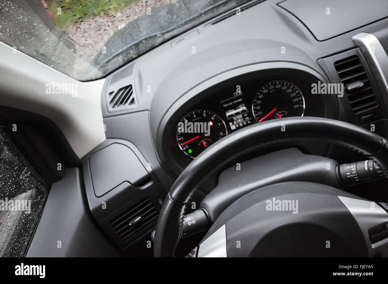 Modern car interior fragment with steering wheel and control panel ...