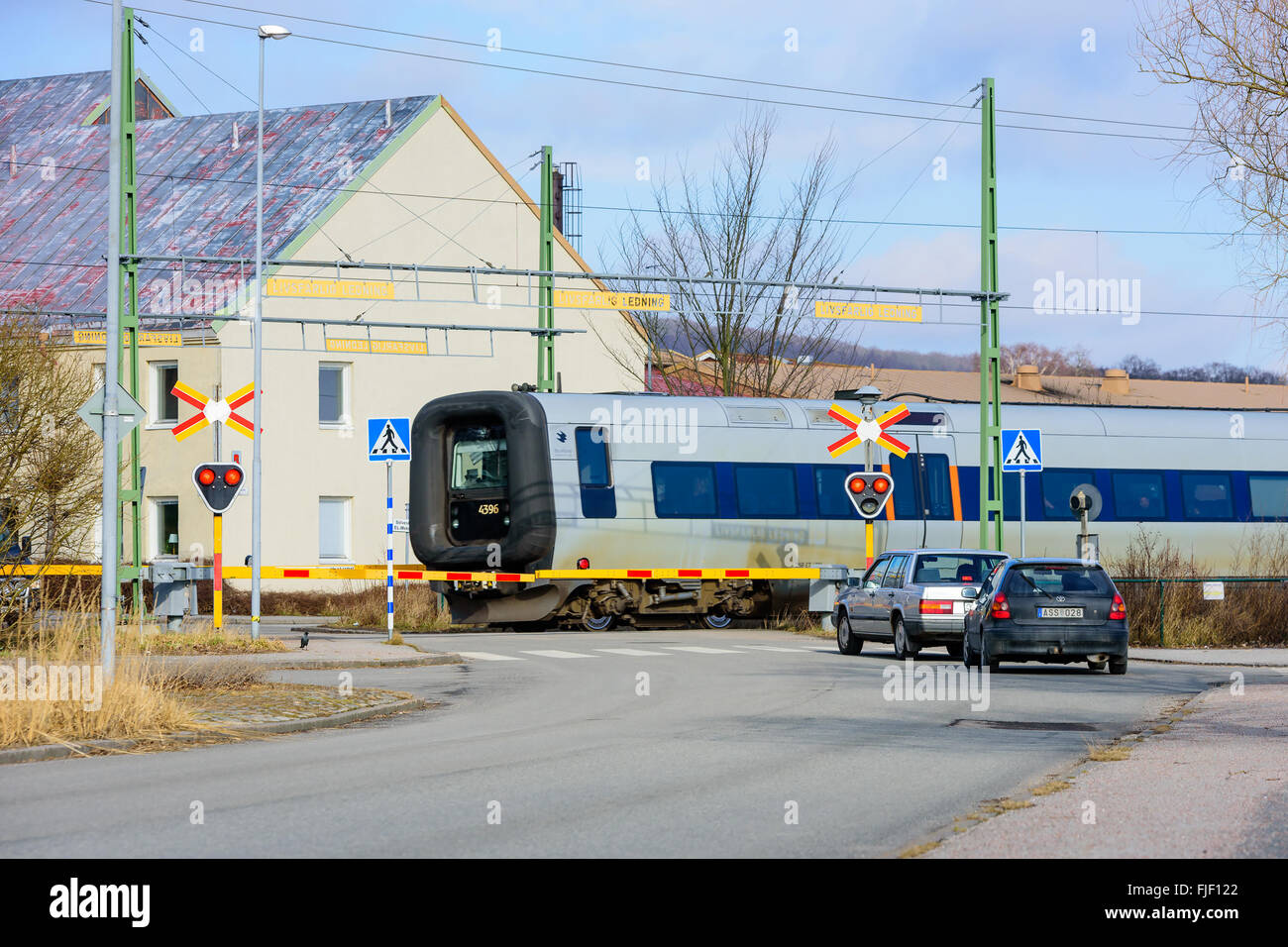 Solvesborg, Sweden - February 27, 2016: Cars are stopped at a railroad ...