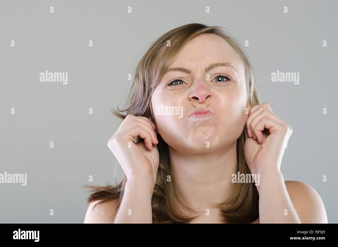 Young woman pulling a funny face Stock Photo - Alamy