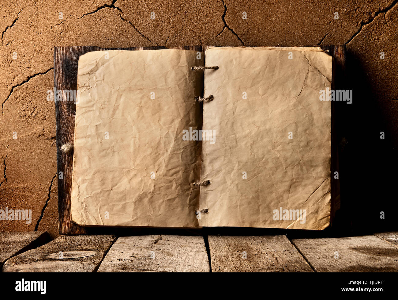 Opened old book on table near clay wall Stock Photo - Alamy
