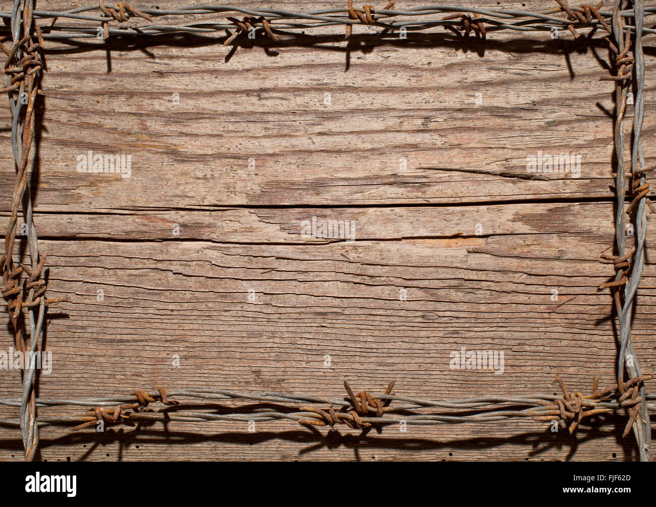 frame made of barbed wire on wooden desk Stock Photo - Alamy