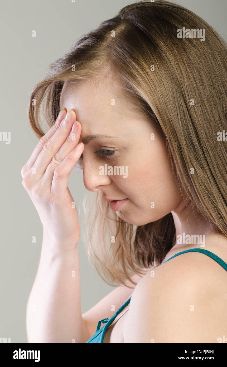 Serious young woman hand touching face Stock Photo - Alamy