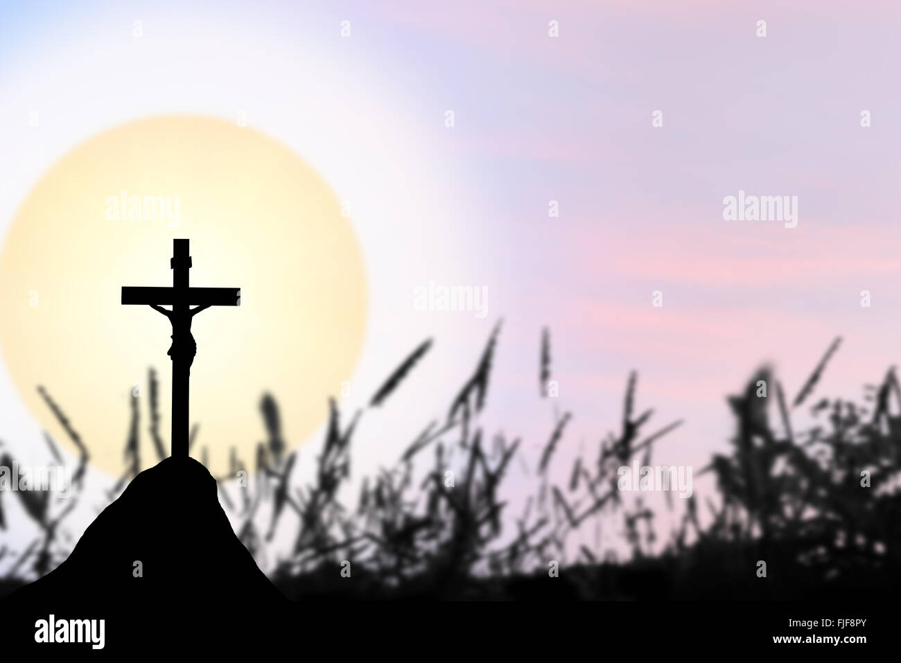 Silhouette Jesus and the cross over sunset on mountain top Stock Photo ...