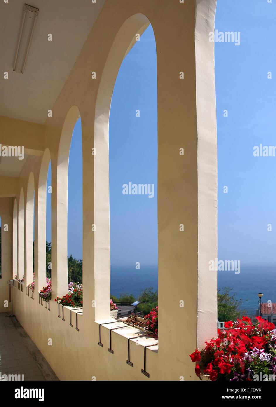 A view of the blue sea through the arches of a colonnade terrace Stock ...