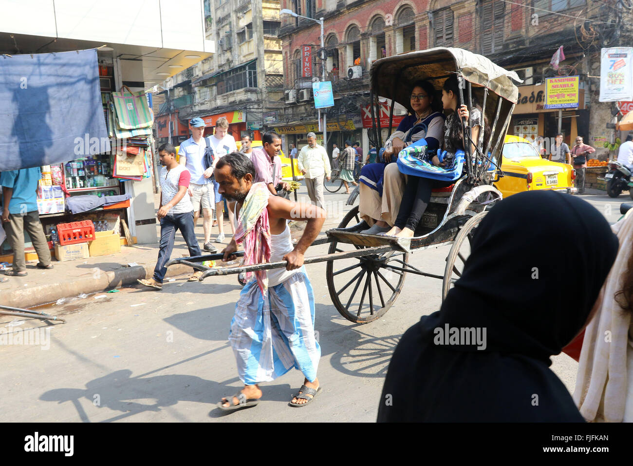 India, 19 February 2016. Hand pulling rickshaw puller pulling with ...