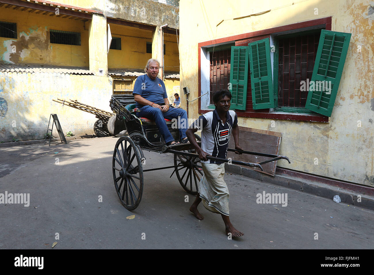 India, 19 February 2016. Hand pulling rickshaw puller pulling with ...