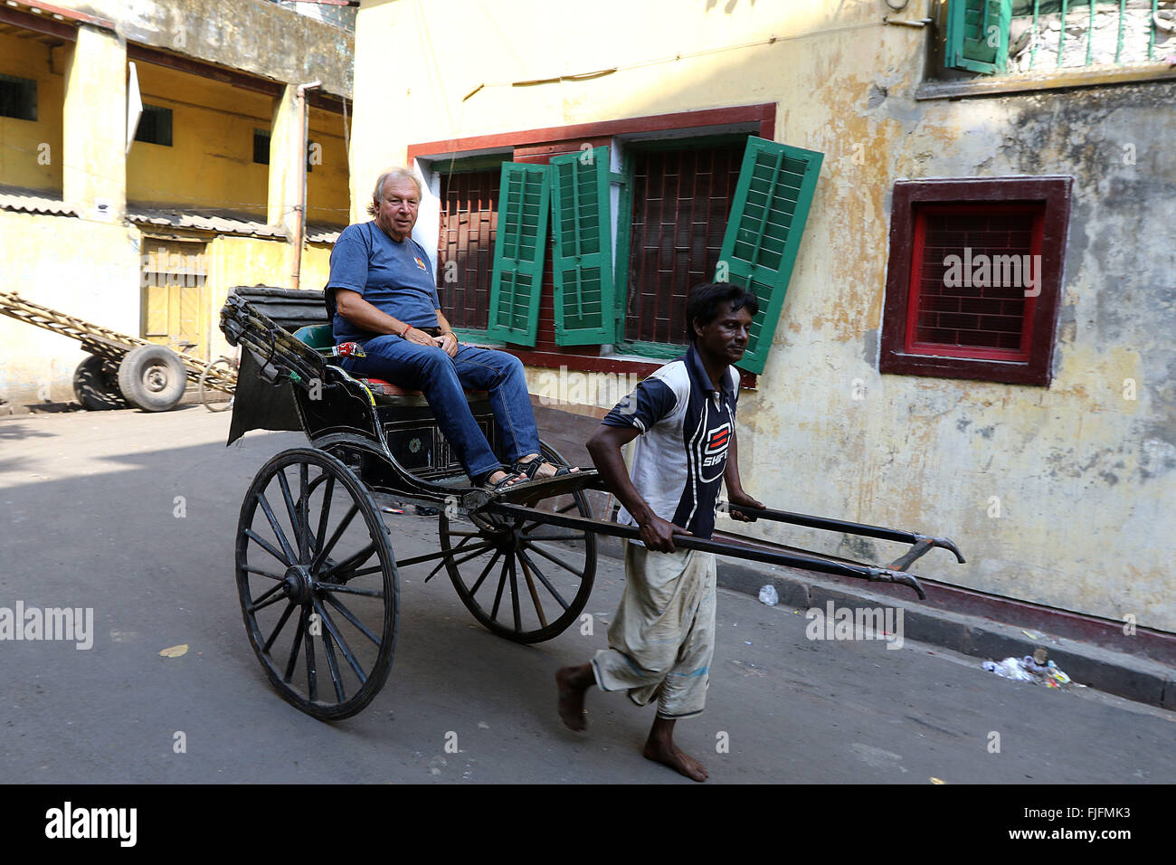 India, 19 February 2016. Hand pulling rickshaw puller pulling with ...