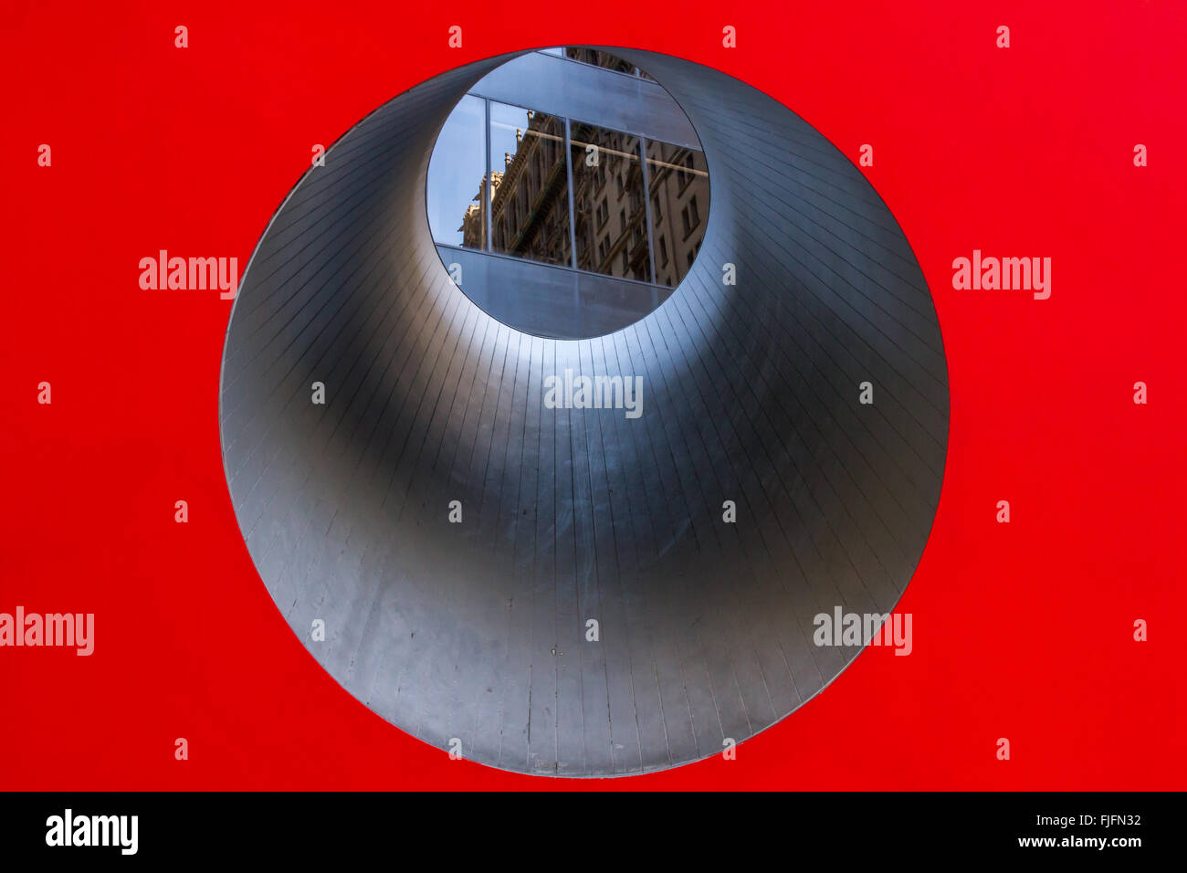 Windows of a building as seen through a hole in a concrete structure ...
