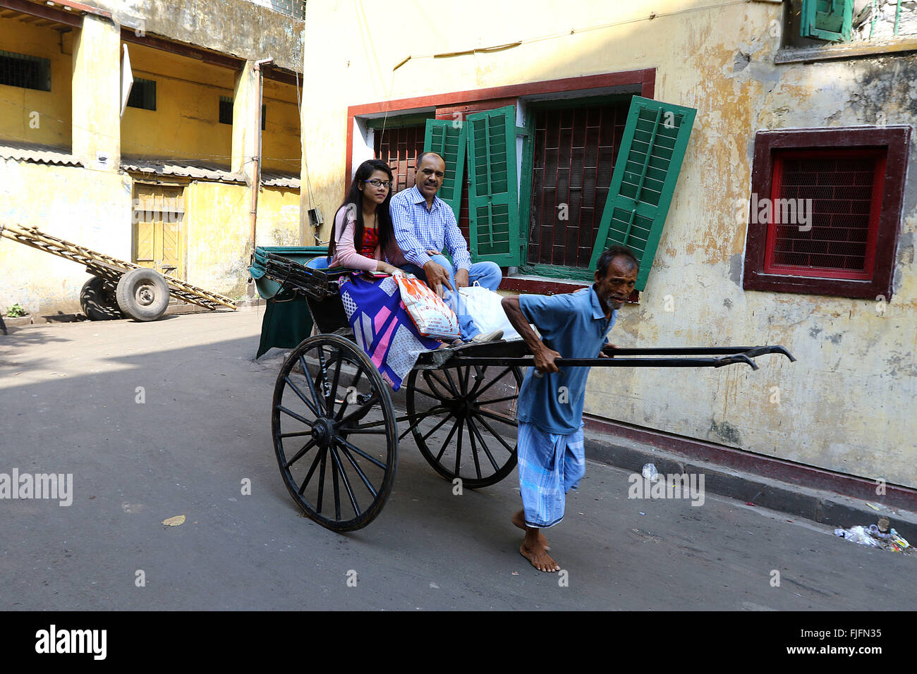 India, 19 February 2016. Hand pulling rickshaw puller pulling with ...