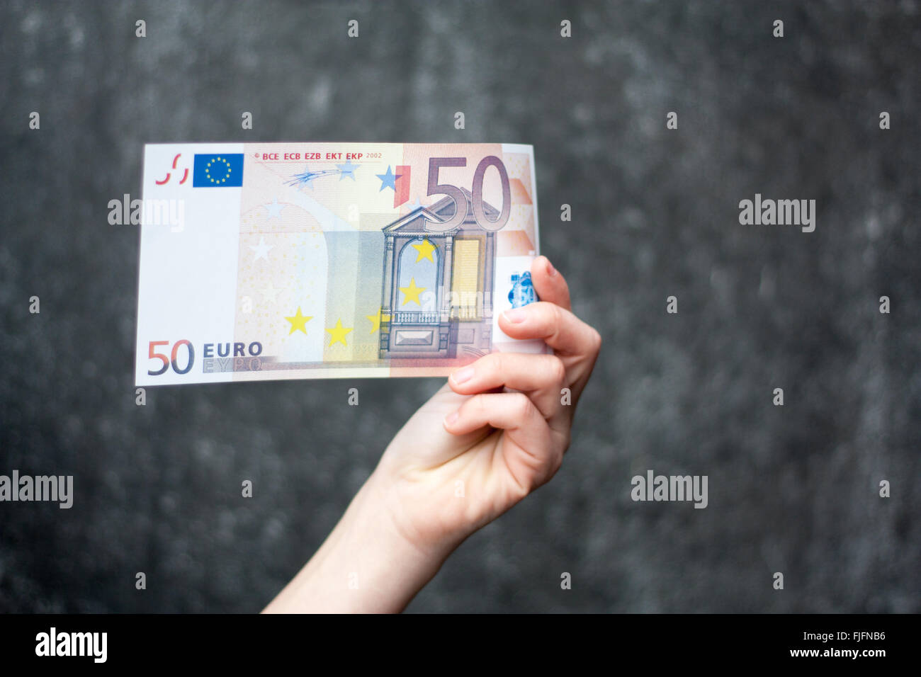 Hand holding fifty euro note Stock Photo - Alamy