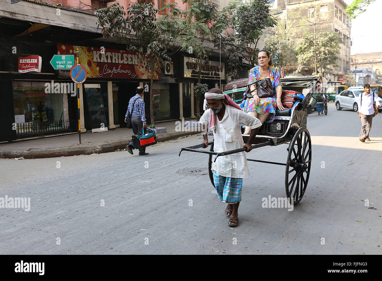 India, 19 February 2016. Hand pulling rickshaw puller pulling with ...