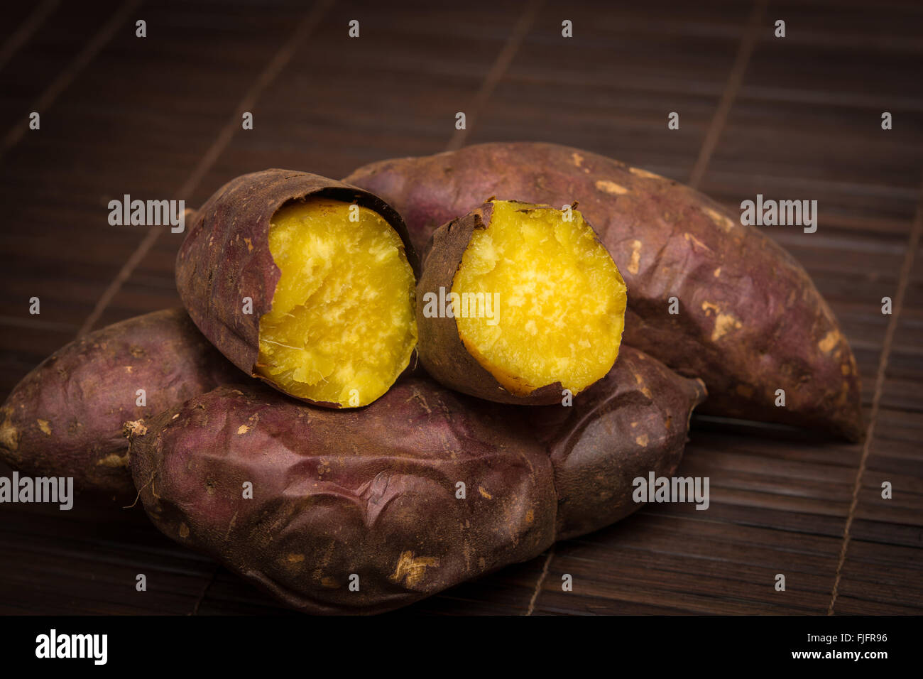 Burned Japanese sweet potato on bamboo mat, with vignette Stock Photo ...