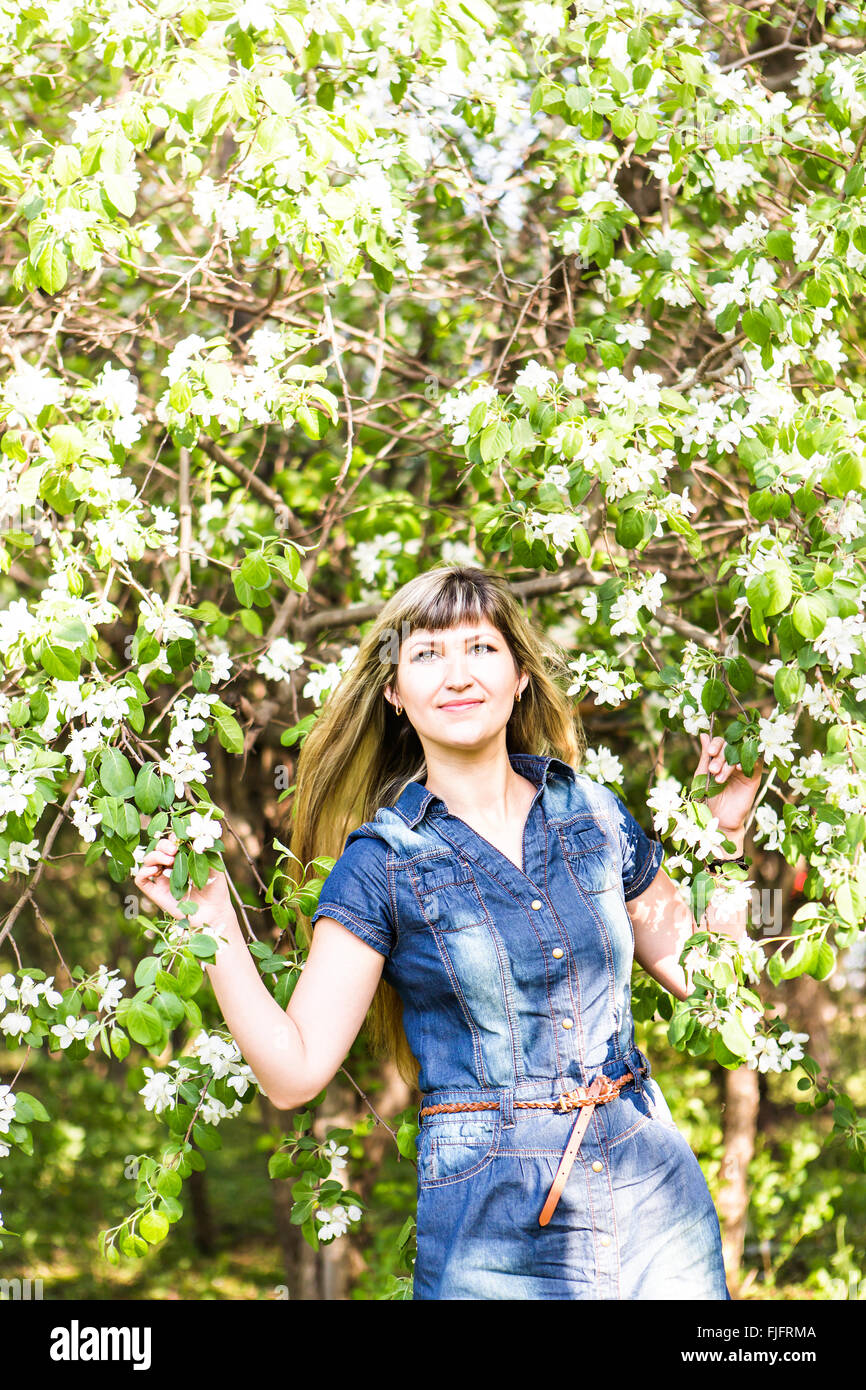 Beautiful spring woman in blooming tree Stock Photo - Alamy