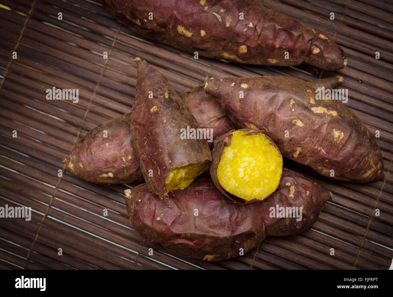 Burned Japanese sweet potato on bamboo mat, with vignette Stock Photo ...
