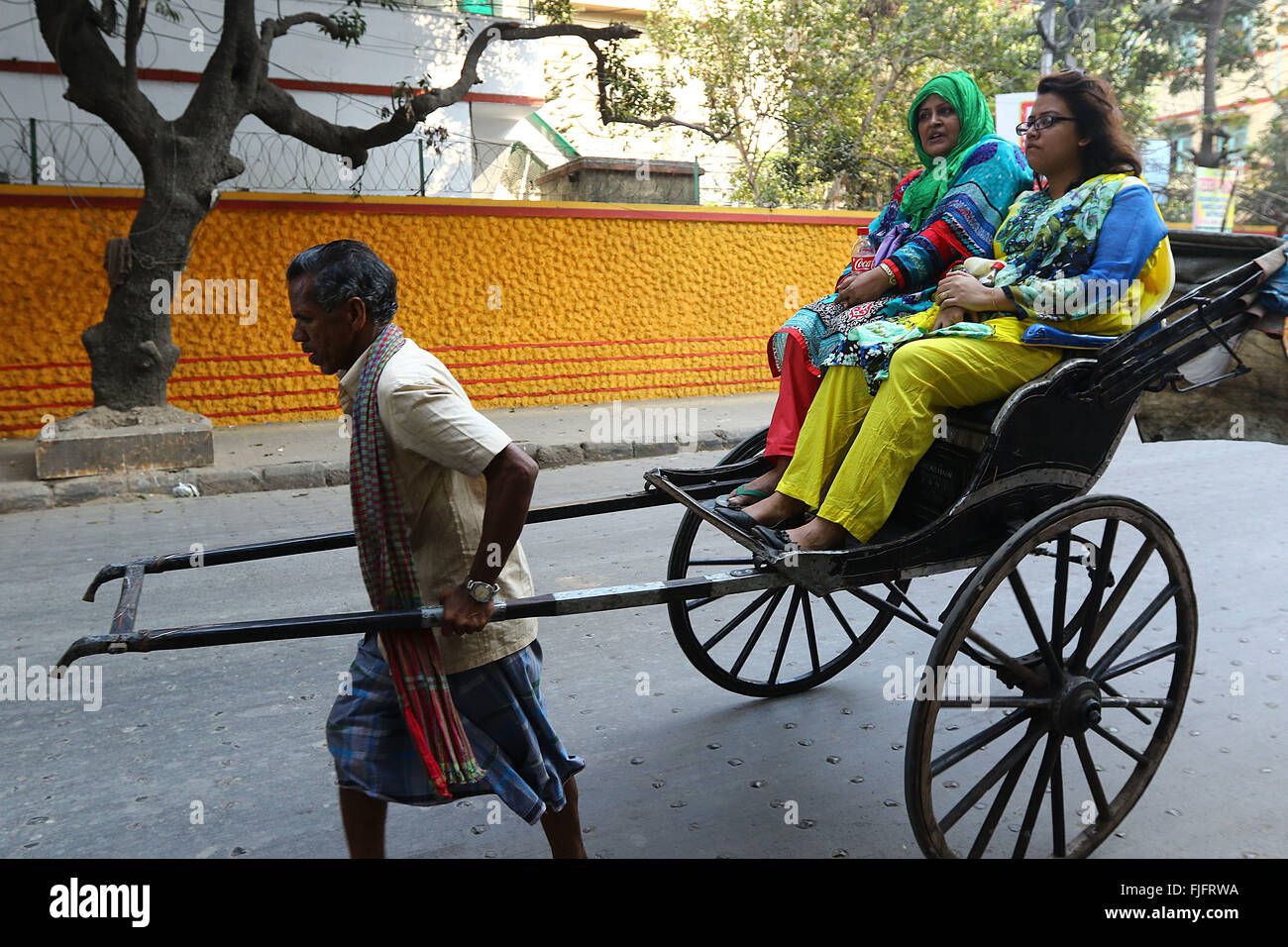 Indian man pulling rickshaw passenger hi-res stock photography and ...
