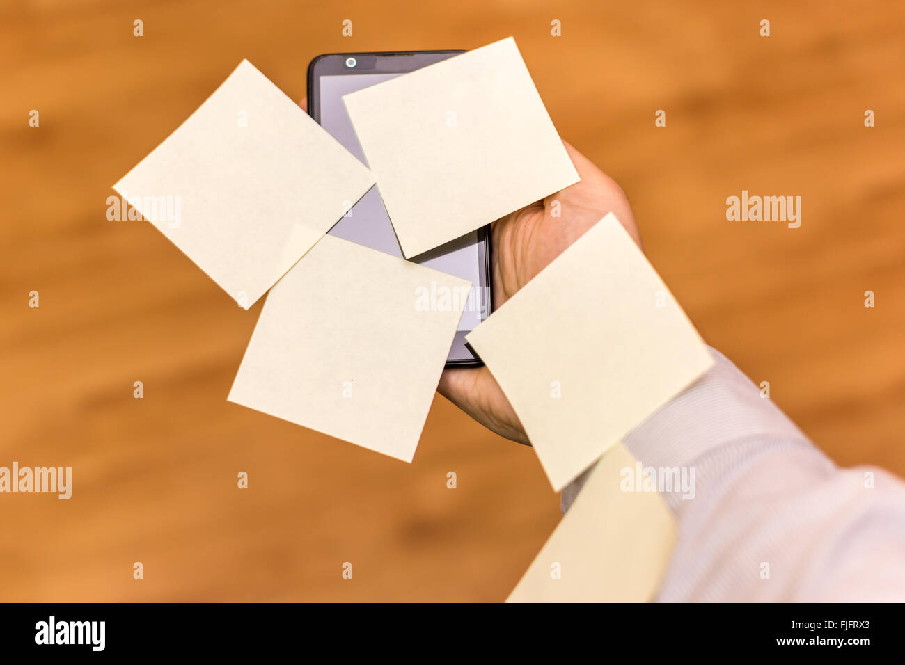 Human hand holdin a smarthpne covered with yellow sticky notes Stock ...