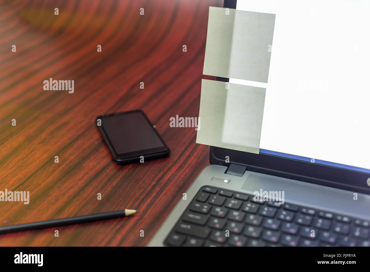 Two blank yellow notes sticked to a laptop display Stock Photo - Alamy