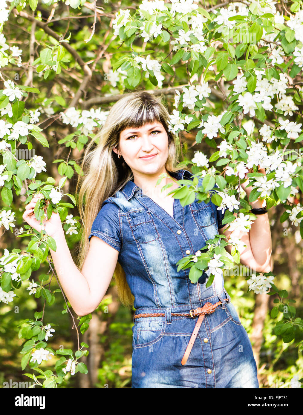 Beautiful spring woman in blooming tree Stock Photo - Alamy