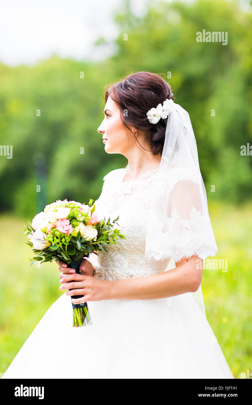 Young bride holding big wedding bouquet Stock Photo - Alamy