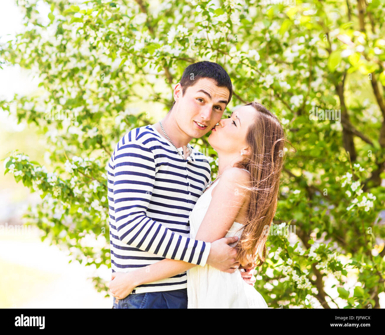 Loving couple under blossoming branches spring day. Young adult ...
