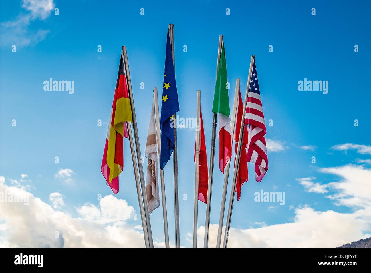 some flags of nations hoisted in the sky Stock Photo - Alamy