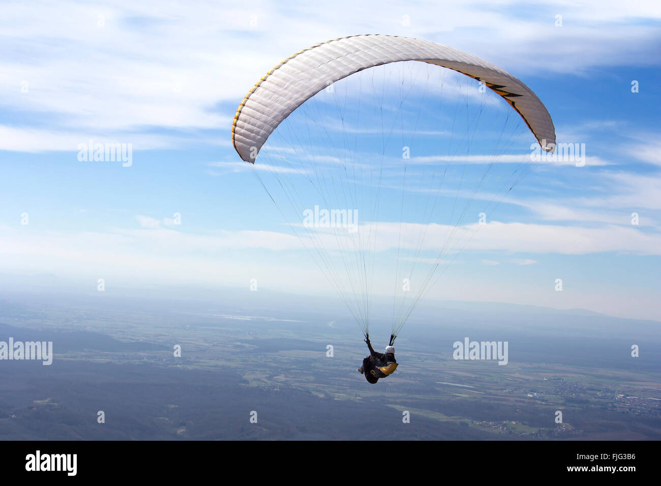 Paraglider flying over mountains to the valley Stock Photo - Alamy
