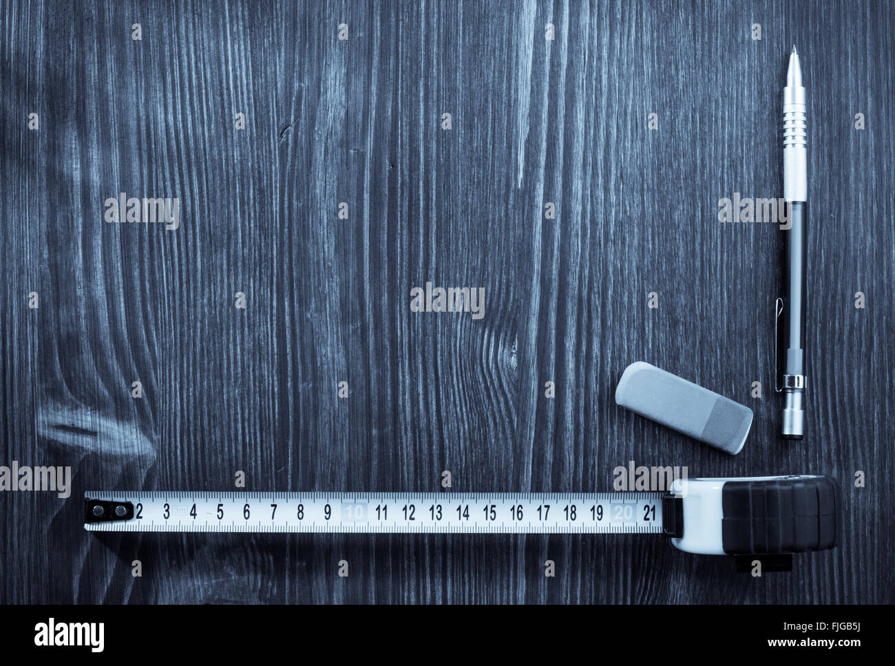 tape measure and pencil on wooden texture Stock Photo - Alamy