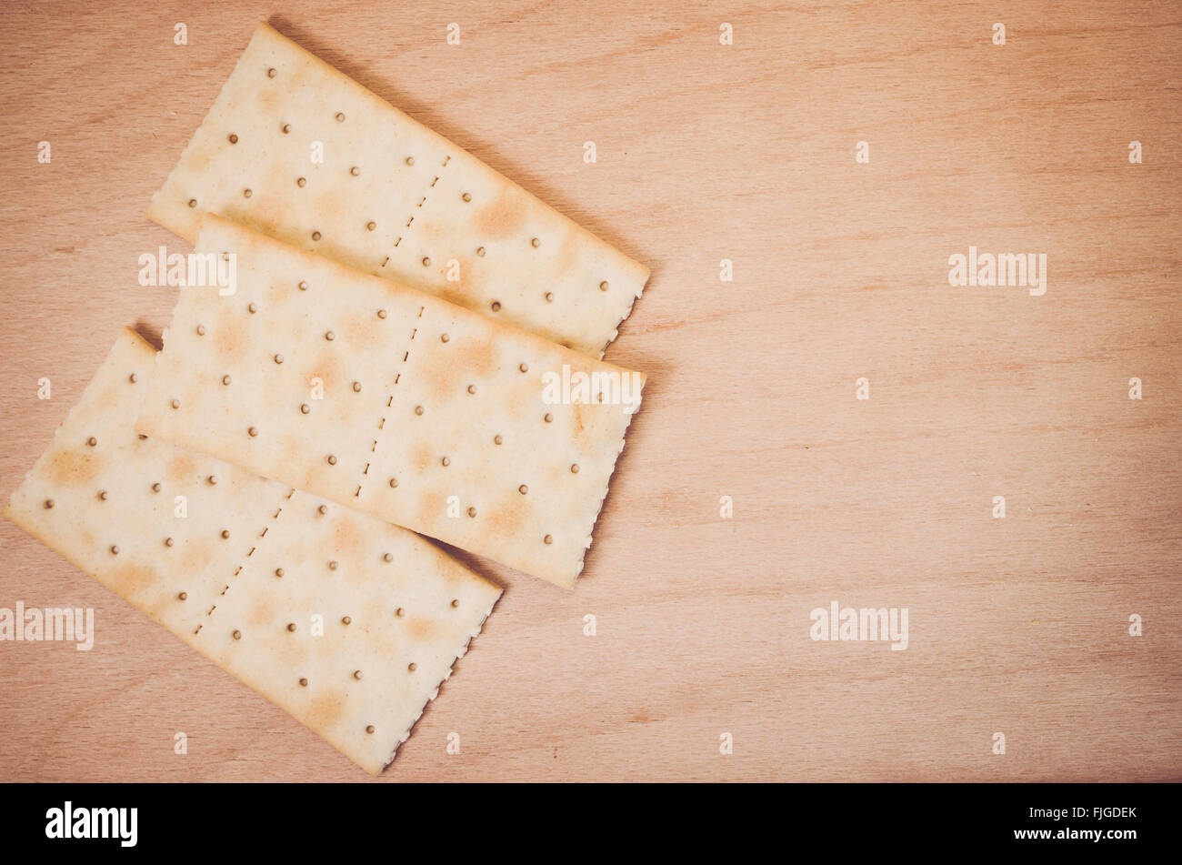 saltine crackers on a wood table surface Stock Photo - Alamy