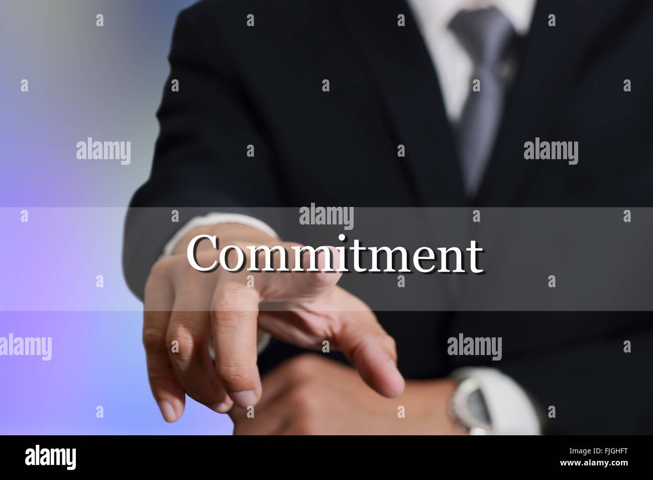 Businessman hand touching commitment sign on virtual screen as ...