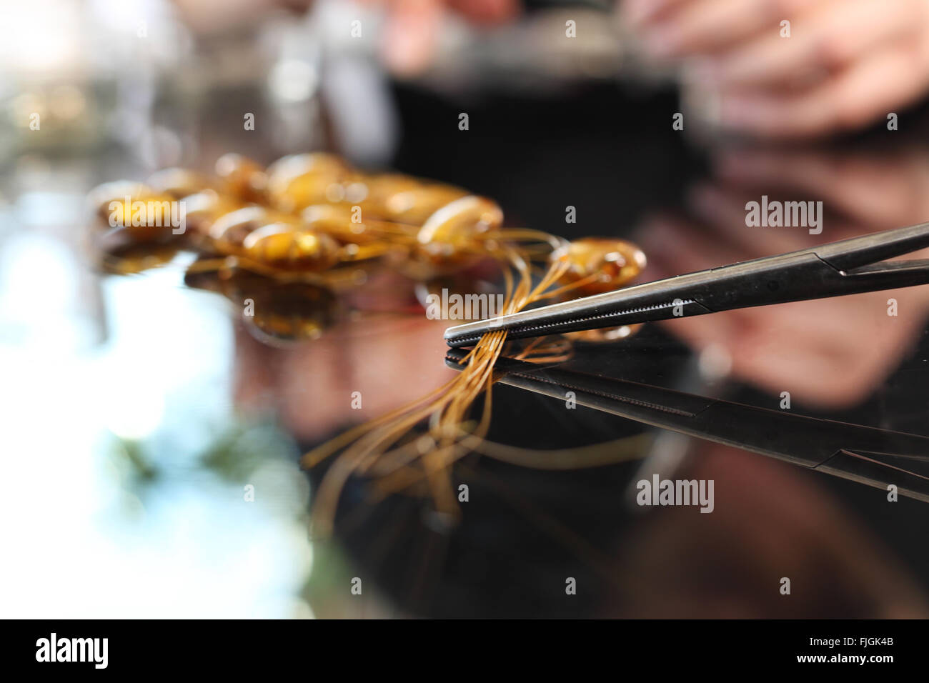 Amber jewelry. Manufactory, a woman carries jewelry made of amber ...