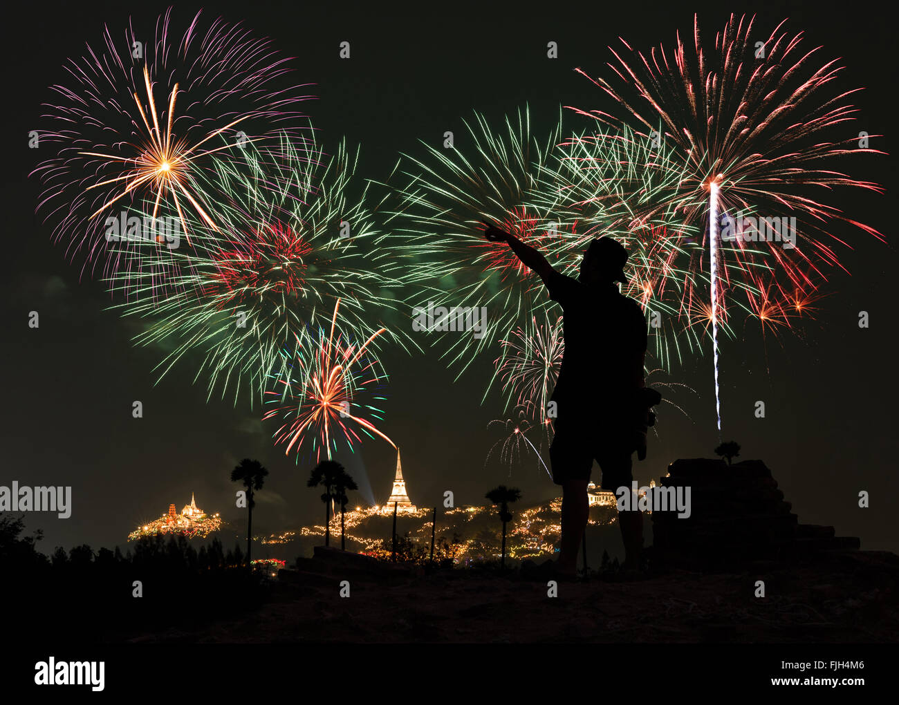 The man looks holiday fireworks in the evening sky Stock Photo - Alamy