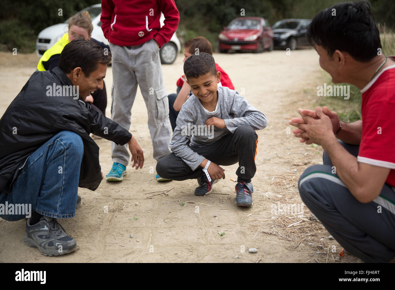 Samos, Greece. 2nd Mar, 2016. Refugees playing Tic-Tac-Toe outside a ...