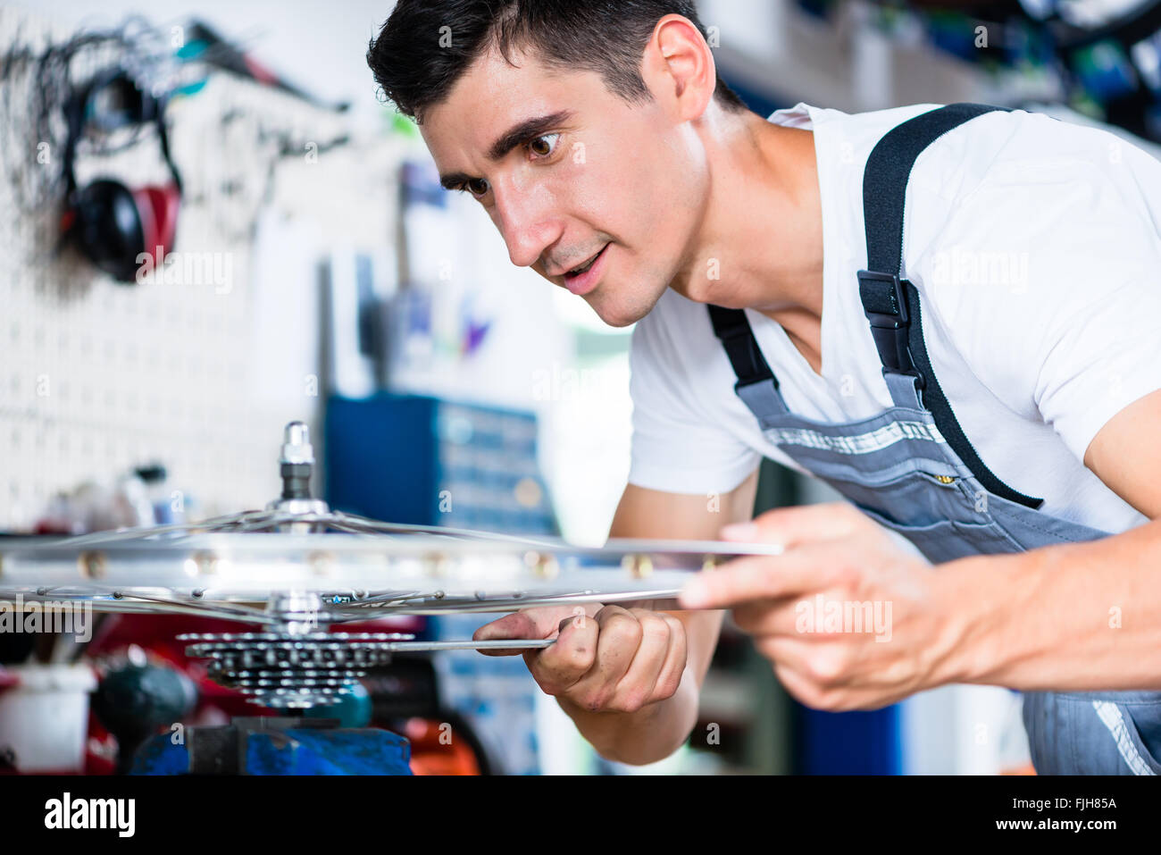 Bicycle mechanic working in his bike workshop Stock Photo - Alamy