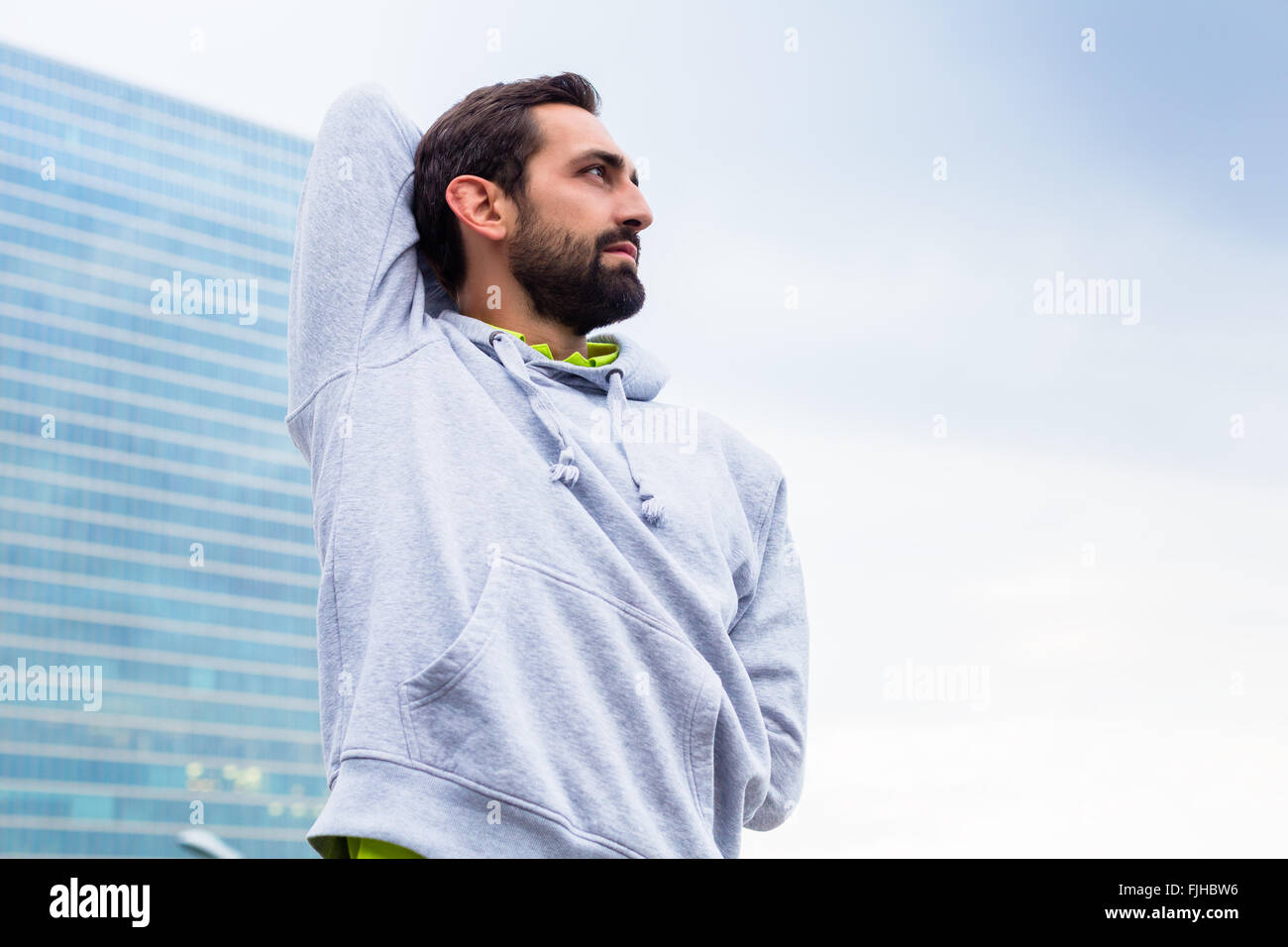 Young man jogging by building hi-res stock photography and images - Alamy
